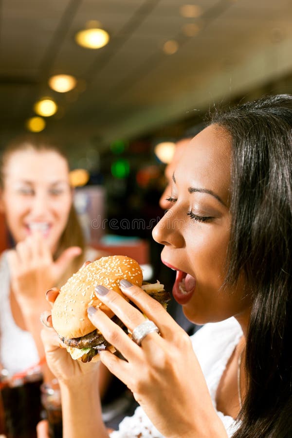 Friends Eating Fast Food in a Restaurant Stock Photo - Image of ...