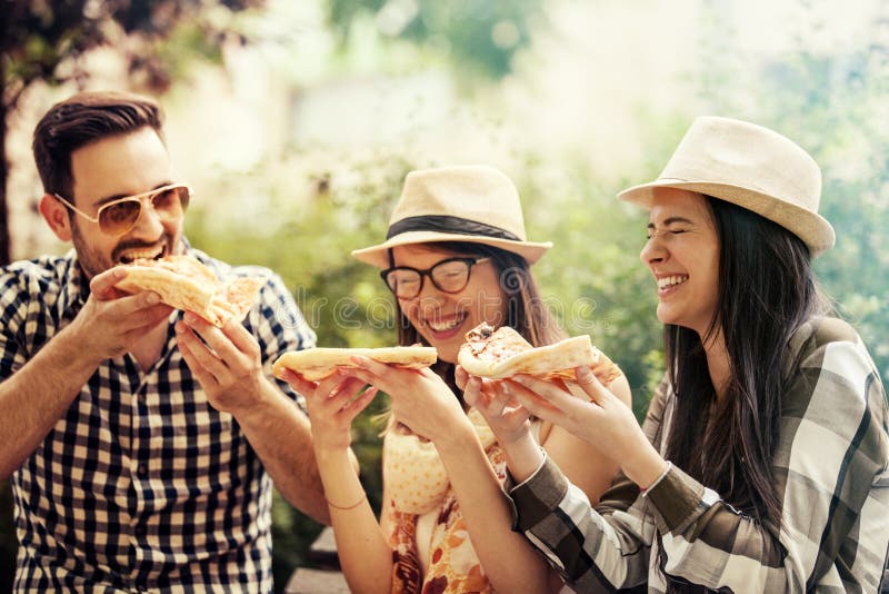 Three Friends Eating Pizza stock photo. Image of boys - 21338982