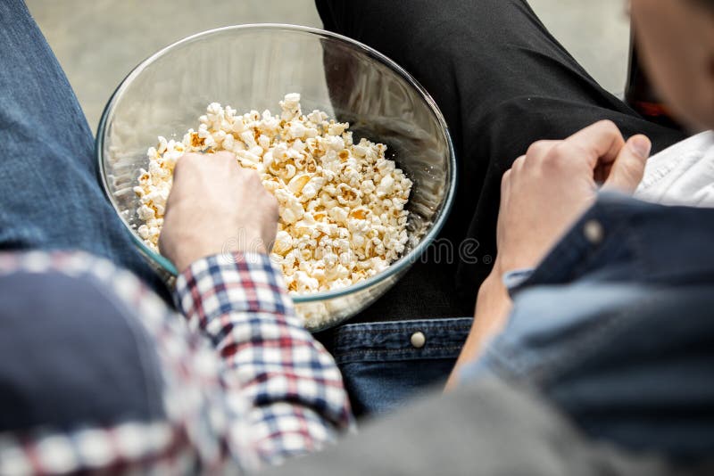 Friends eating popcorn stock photo. Image of home, tasty - 89568850