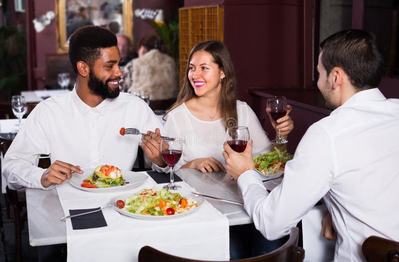 Friends Eating at Restaurant Table and Chatting Stock Image - Image of ...