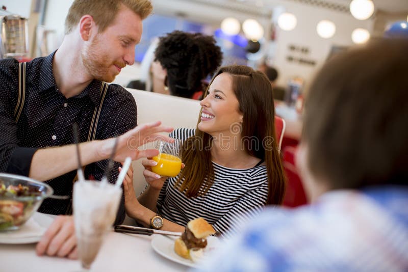 Friends Eating at the Table in the Diner Stock Photo - Image of table ...