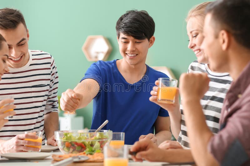 Friends Eating at Table in Kitchen Stock Image - Image of preparation ...