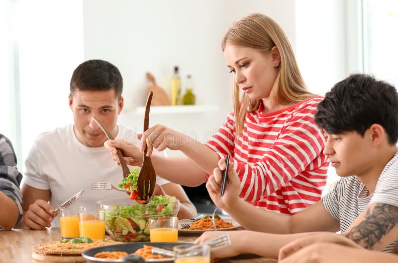 Friends Eating at Table in Kitchen Stock Photo - Image of leisure ...