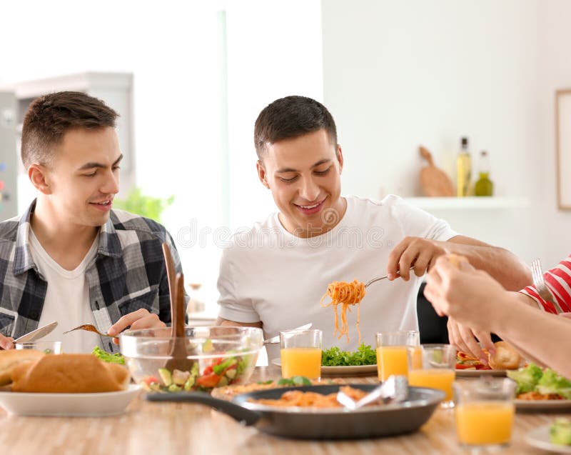 Friends Eating at Table in Kitchen Stock Image - Image of indoors ...