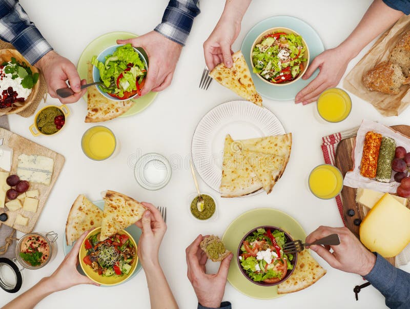 Friends eating at table stock image. Image of homemade - 67436543