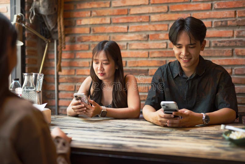 Friends Eating Together in Restaurant and Using Phone Stock Photo ...