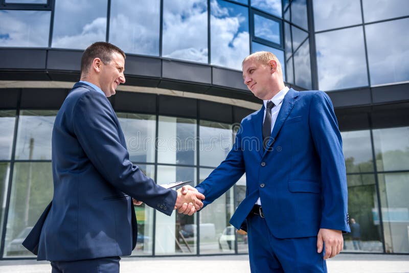 Friends in Elegant Business Suits Handshaking Outdoors Stock Image ...