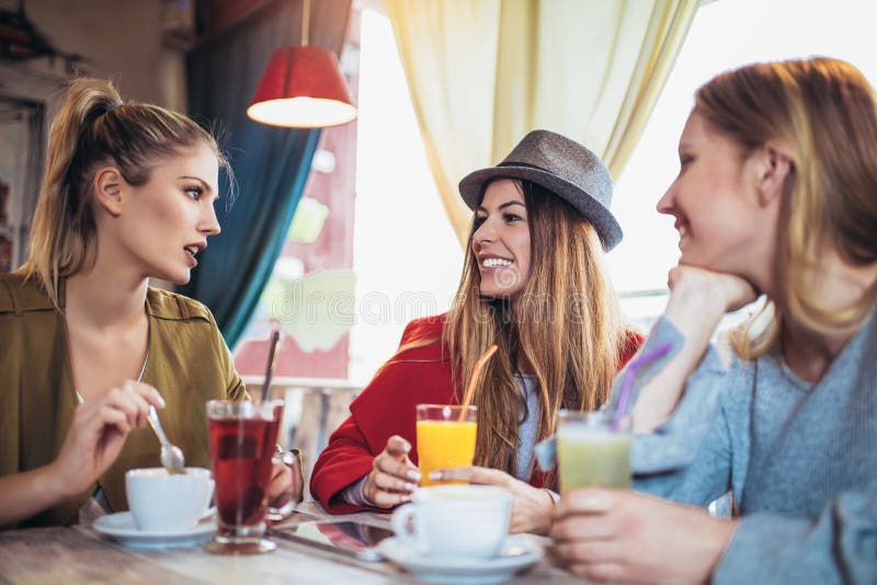 Friends Enjoying in Conversation and Drinking Coffee in Cafe Stock ... Friends Enjoying in Conversation and Drinking Coffee in Cafe Stock ...