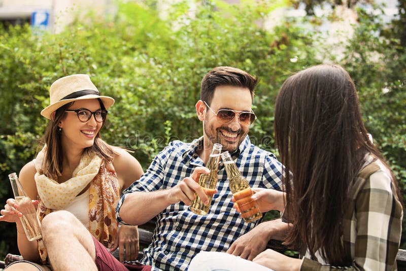 Friends enjoying outside stock image. Image of outgoing - 78034625