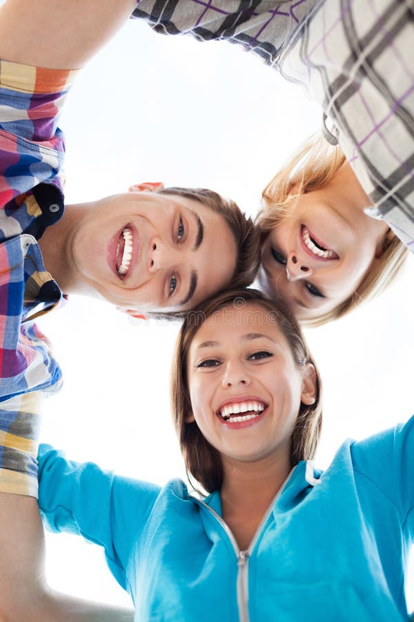 Three girls in a huddle stock image. Image of embracing - 20890853