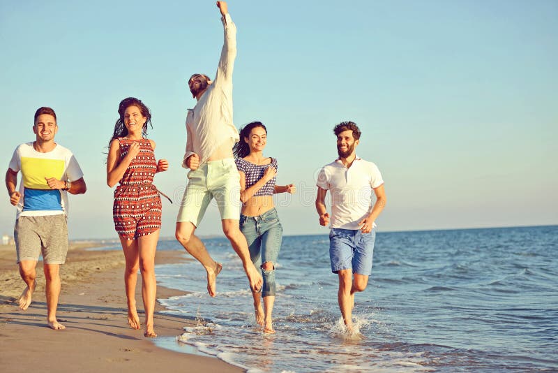 Friends Fun on the Beach Under Sunset Sunlight. Stock Photo - Image of ...
