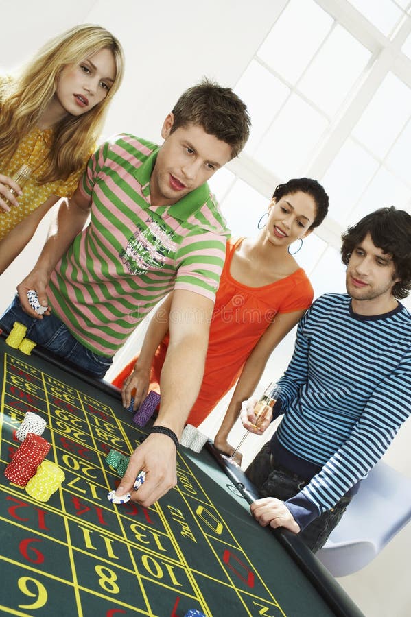 Friends Gambling at Roulette Table Stock Image - Image of activity ...