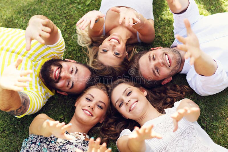 Friends Group Having Fun Together on Grass Stock Image - Image of grass ...