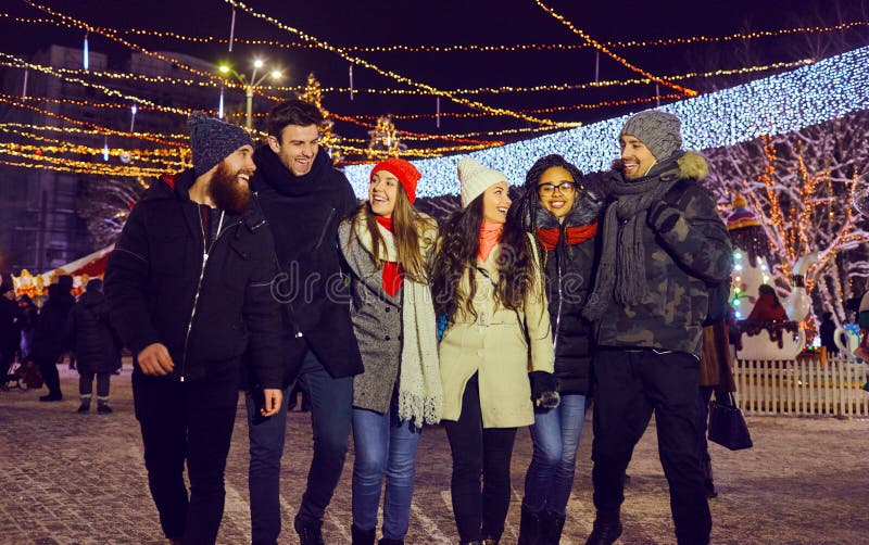Friends Have Fun Walking on Christmas Streets at Night. Stock Image ...