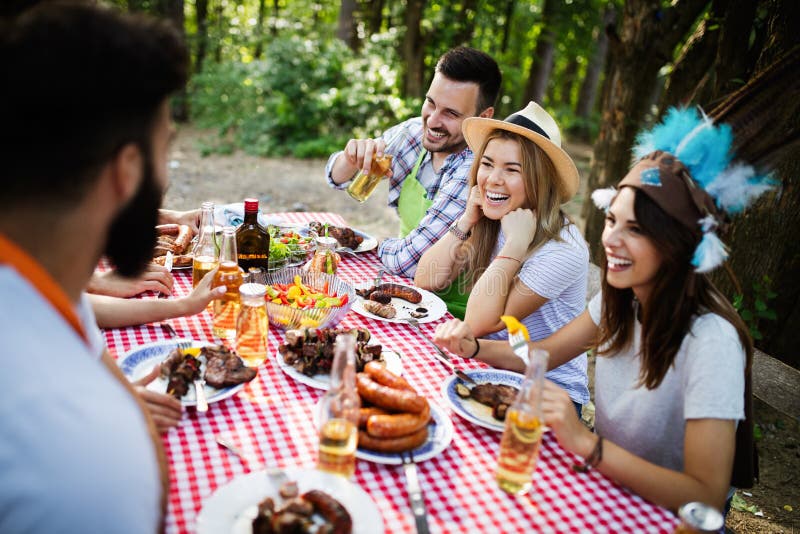 Friends Having a Barbecue Party in Nature while Having Fun Stock Photo ...
