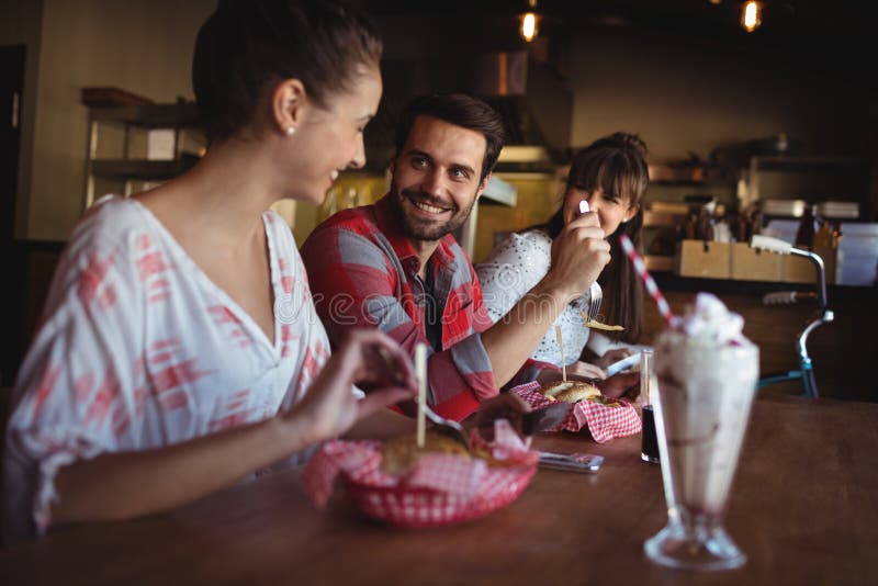 Friends Having Burger Together Stock Image - Image of holding ...
