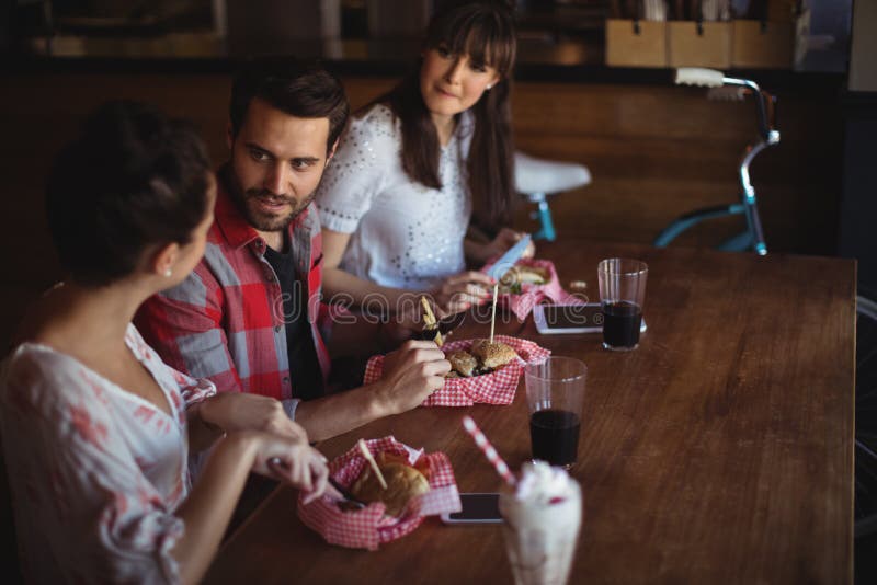 Friends Having Burger Together Stock Photo - Image of food, hotel: 91737638