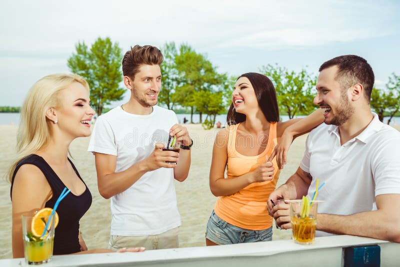 Friends Having Fun at the Bar Outdoors, Drinking Cocktails. Stock Image ...