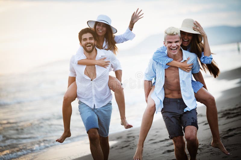 Friends Having Fun on the Beach Under Sunset Sunlight. Stock Image ...