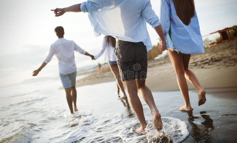 Friends Having Fun on the Beach Under Sunset Sunlight. Stock Image ...