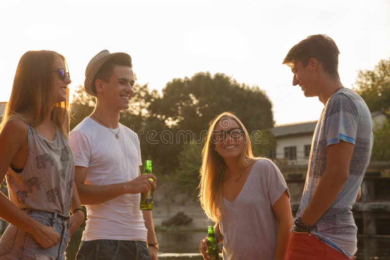Friends Having Fun Near Lake Stock Image - Image of drink, happiness ...
