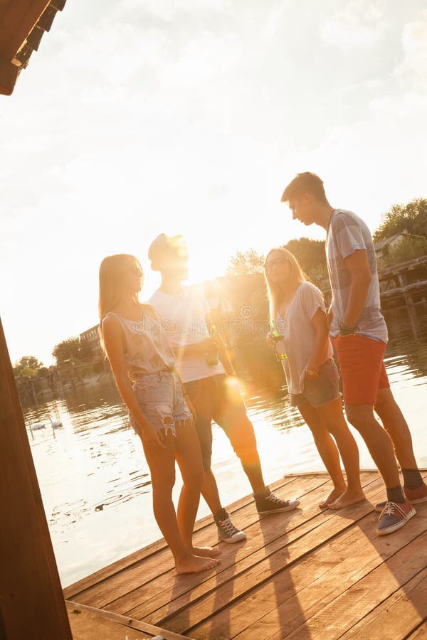 Friends Having Fun Near Lake Stock Photo - Image of female, cottage ...