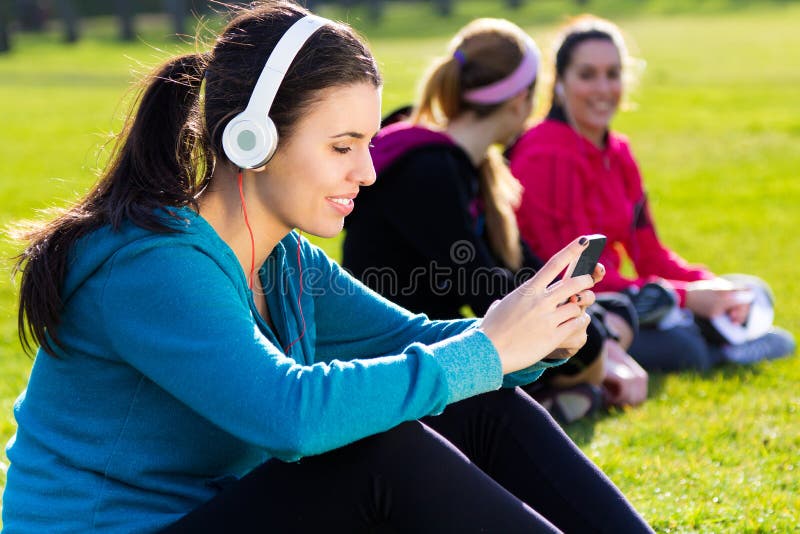Friends Having Fun with Smartphones after Exercise Stock Image - Image ...