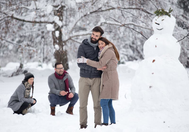 Friends having fun on snow stock image. Image of outdoor - 163124401