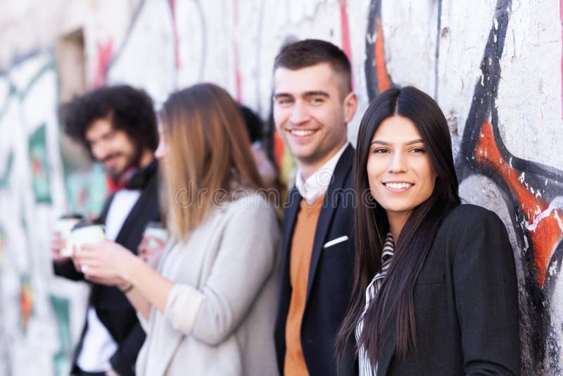 Friends Having Fun Time Outdoors. Group of People Posing on a Wall with ...
