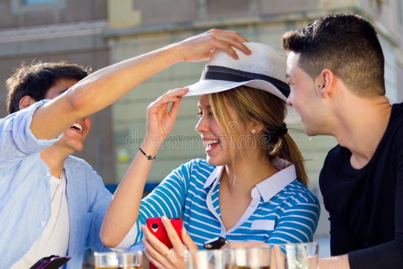 Friends Having Fun with White Hat in the Street Stock Image - Image of ...