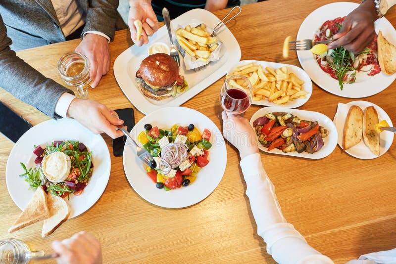 Friends Having a Hearty Lunch in the Restaurant Stock Photo - Image of ...
