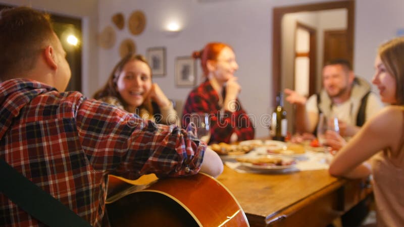 Friends Having a Party - Drinking and Singing Songs by the Guitar Stock ...