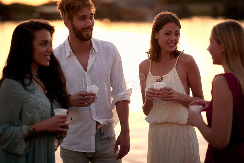 Friends Having Party at Evening - Happy People Drinking and Having Fun ...