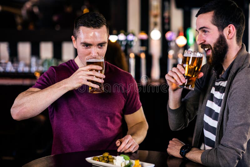 Friends having a pint stock photo. Image of glass, communication - 66147740
