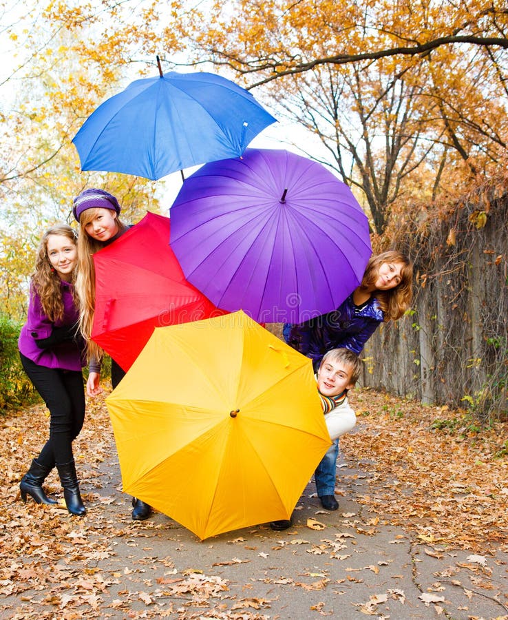 Friends Hiding Behind Umbrellas Stock Image - Image of hide, foliage ...