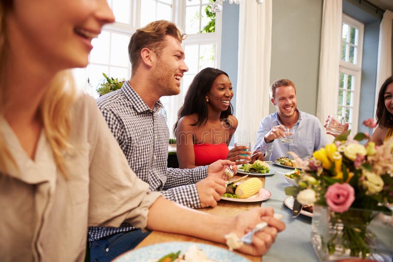 Friends at Home Sitting Around Table for Dinner Party Stock Image ...