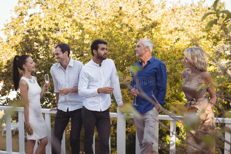 Friends Interacting with Each Other while Having Champagne in Balcony ...