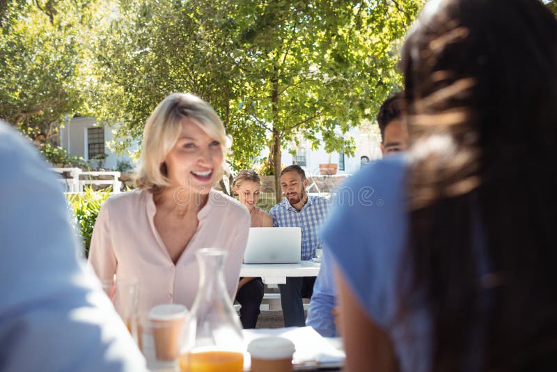 Friends Interacting with Each Other in Restaurant Stock Photo - Image ...