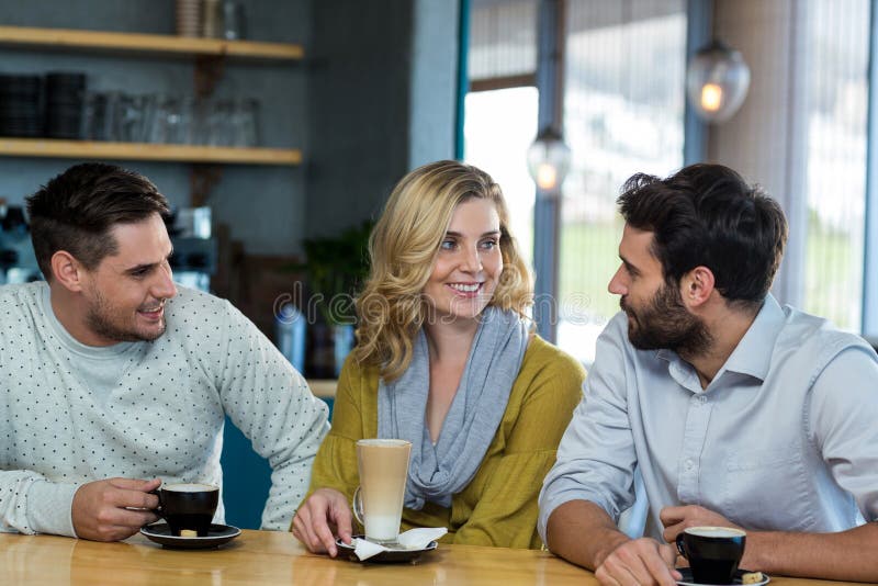 Friends Interacting while Have a Cup of Coffee Stock Photo - Image of ...