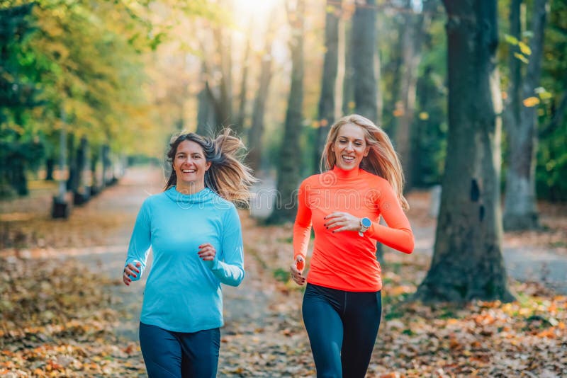 Friends Jogging Outdoors in a Public Park. Autumn, Fall Stock Photo ...