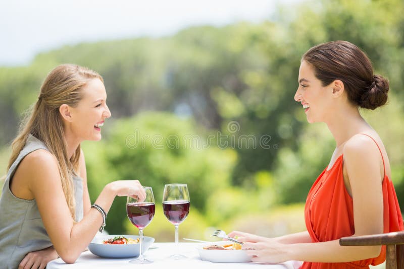 Friends Laughing while Having Food Stock Photo - Image of laughing ...