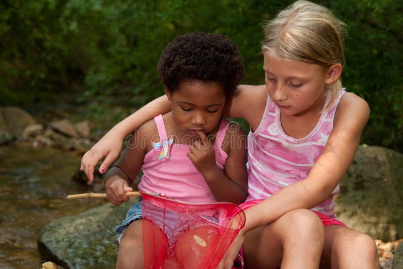 Friends Looking into a Net. Stock Image - Image of fish, outdoors: 26122583