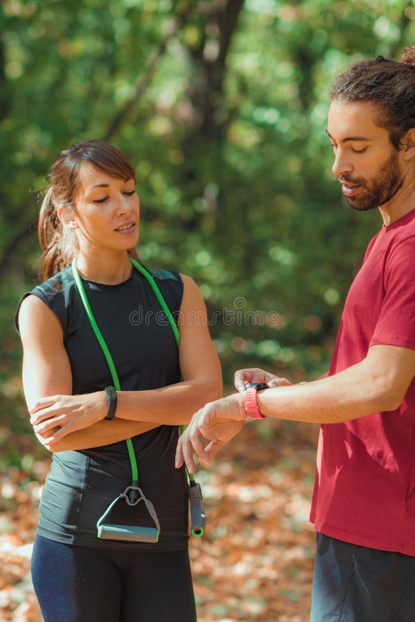 Friends Looking at Their Smart Watches after Outdoor Training Stock ...