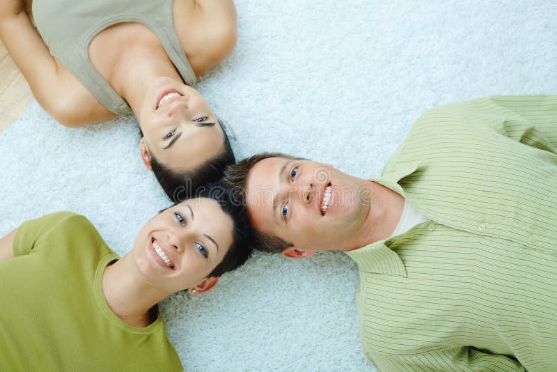 Friends lying on floor stock image. Image of expression - 9334239