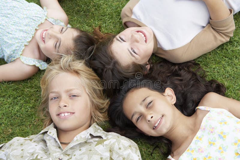 Friends Lying Together on Grass Stock Image - Image of lawn, children ...