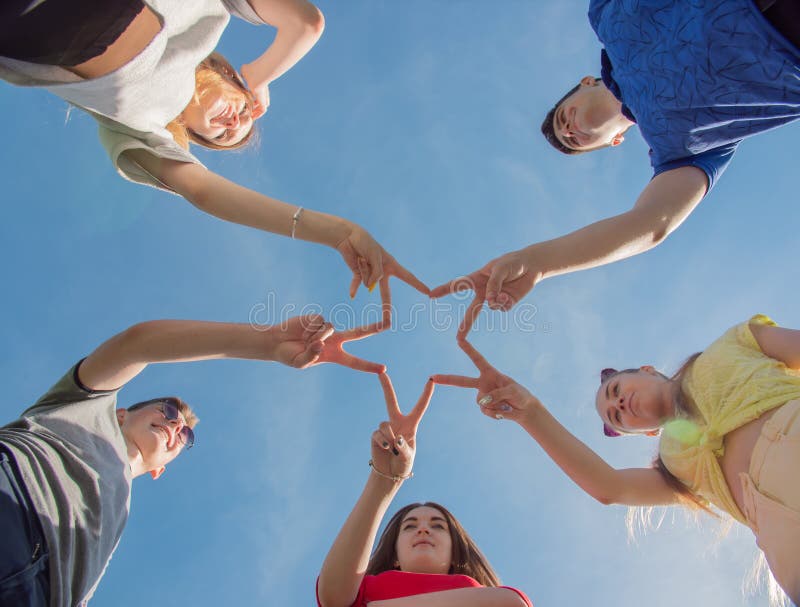A Group of Friends Make a Circle Shape Out of Their Hands. the Concept ...