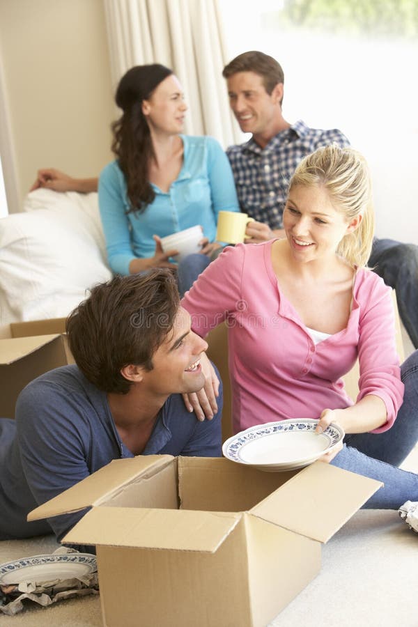 Friends Moving into New Home Unpacking Boxes Stock Image - Image of ...