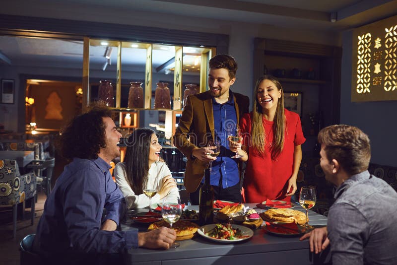 Friends at a Party in a Restaurant Talking at the Table Stock Image ...