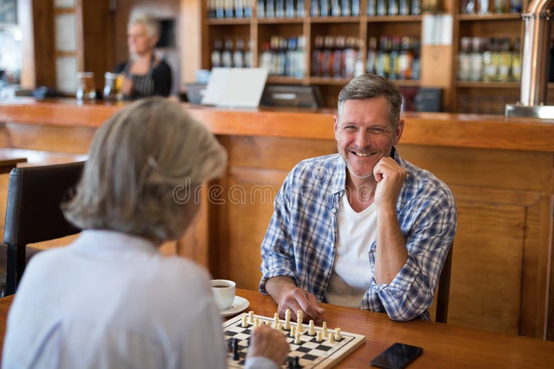 Friends Playing Chess in Bar Stock Photo - Image of adult, board: 102566502