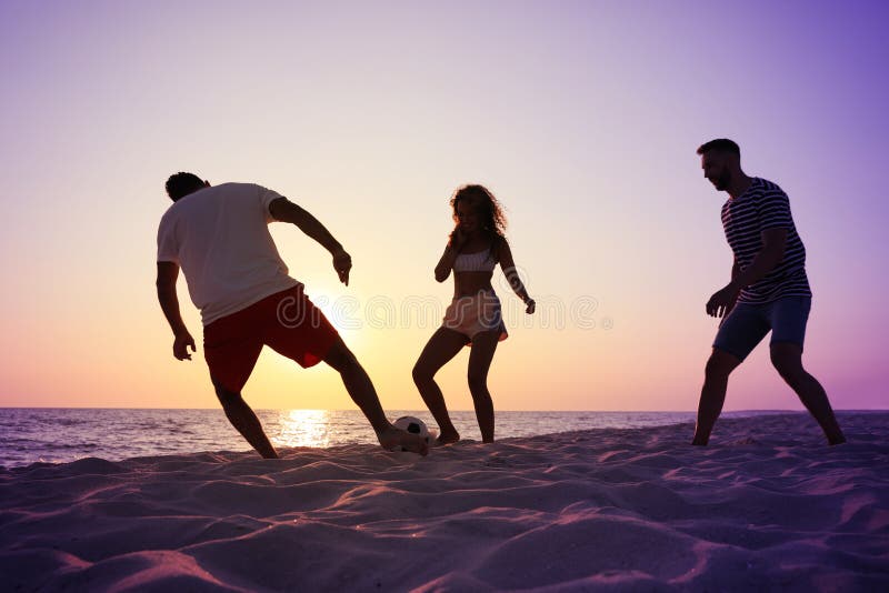 Friends Playing Football on Beach at Sunset Stock Image - Image of game ...